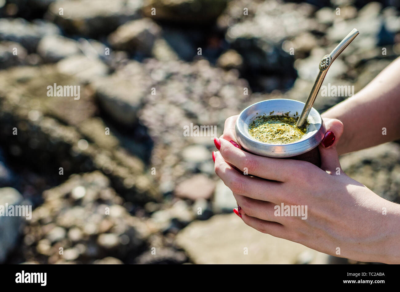 Woman drinking traditional Argentinian yerba mate tea from calabash ...