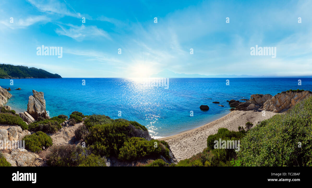 Summer morning sunshiny sandy beach and rocky coast near Platanitsi ...