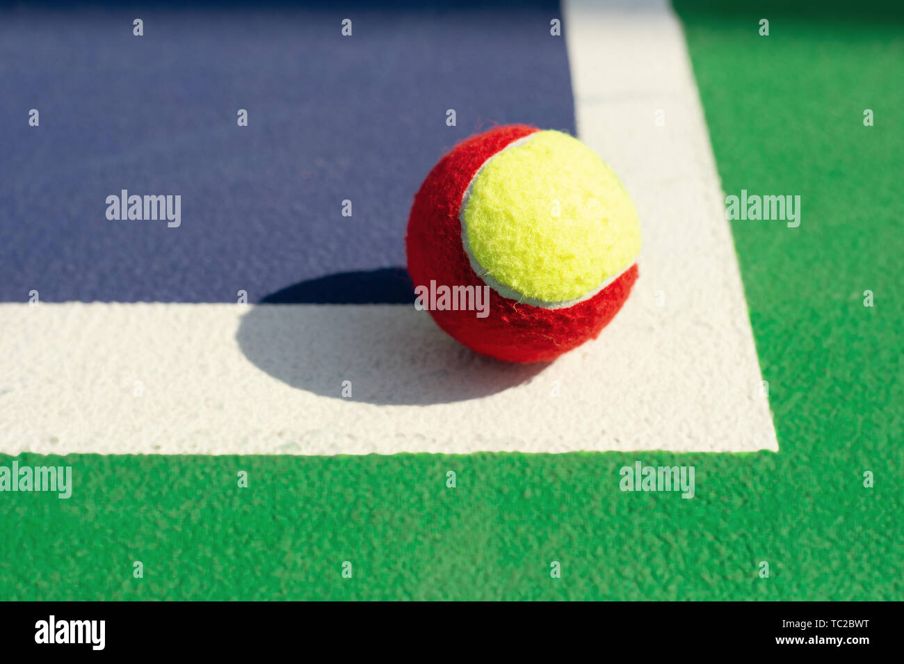A tennis ball on the line Stock Photo - Alamy