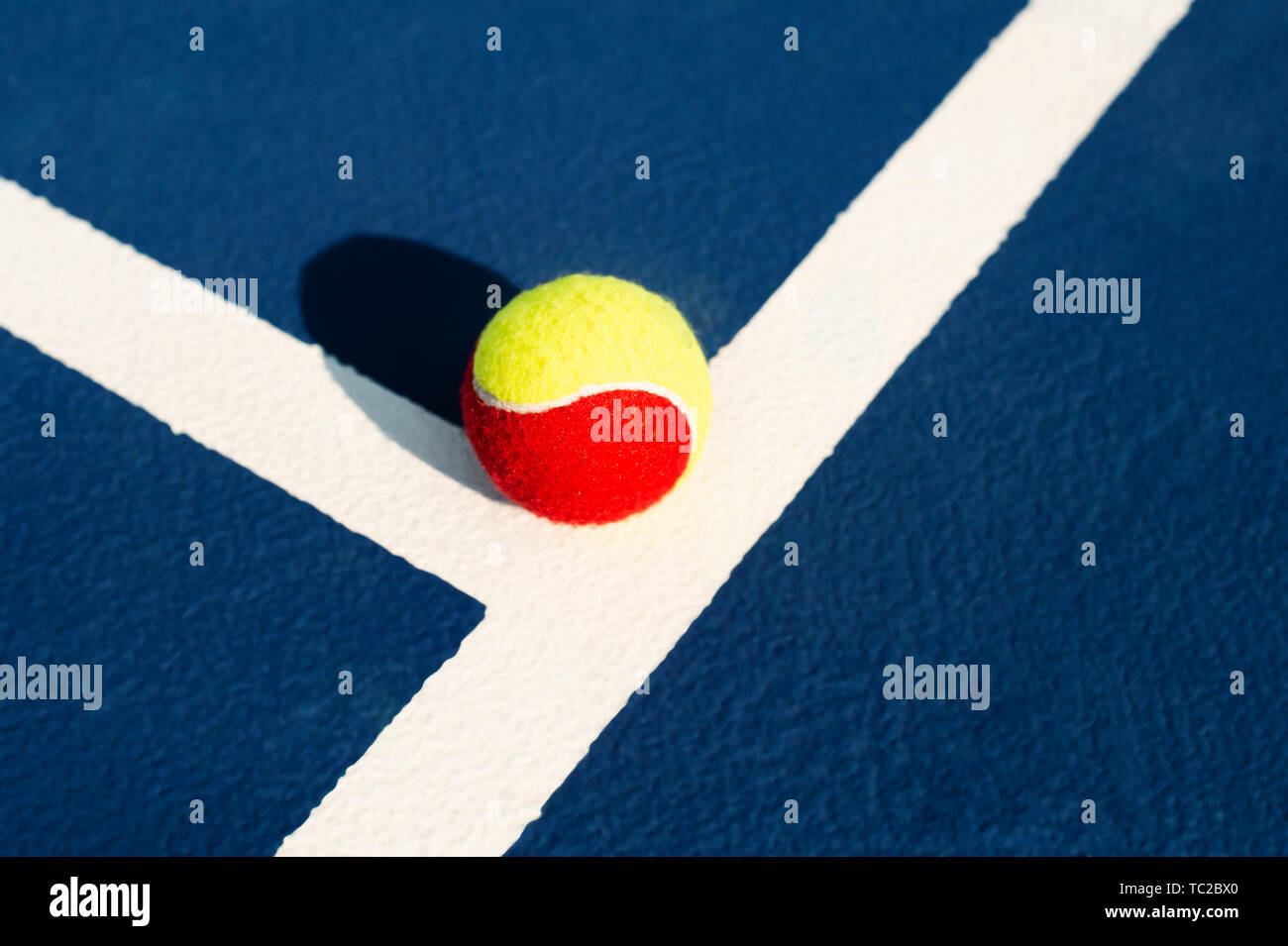 A tennis ball on the line Stock Photo - Alamy