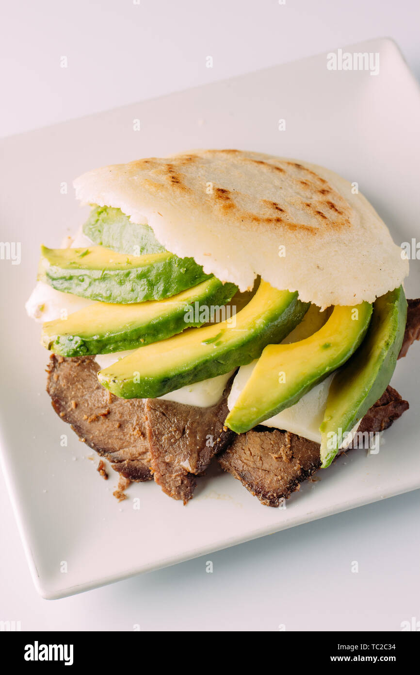 Arepa llanera, South American food on white plate Stock Photo - Alamy