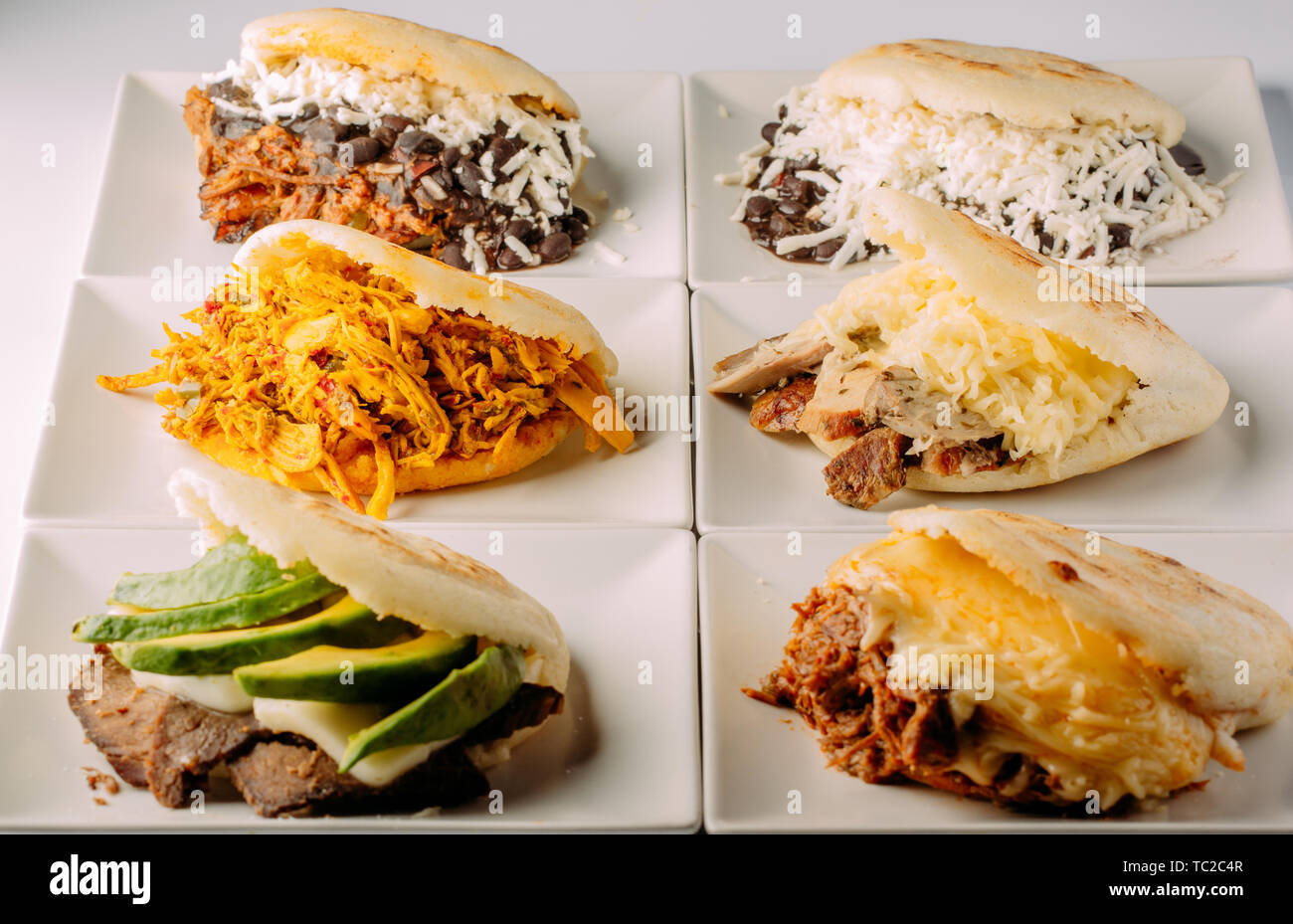 Group of arepas stuffed with various ingredients, Latin American food ...
