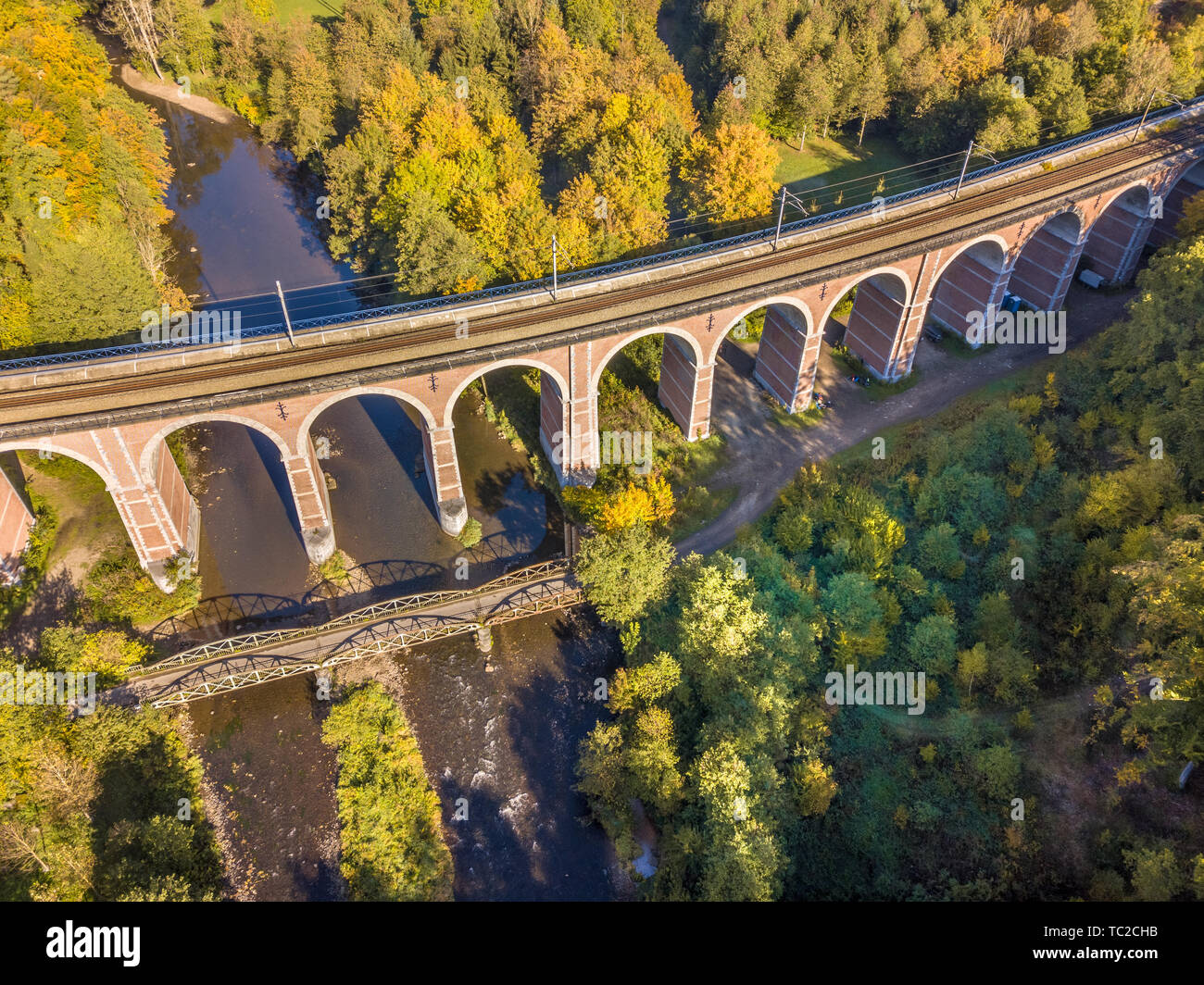 Aerial view of Old Stone railroad bridge crossing river near village of ...