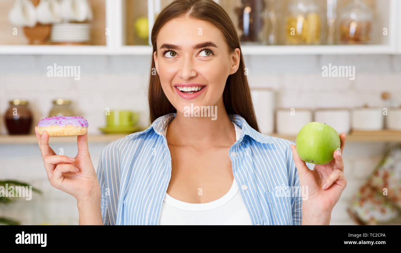Healthy Food. Woman Choosing Between Fruits And Sweets Stock Photo - Alamy