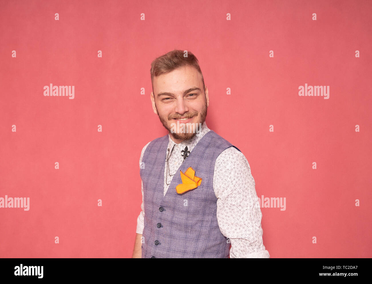 one young man, 20-29 years old, smiling at the camera, shot in a studio ...