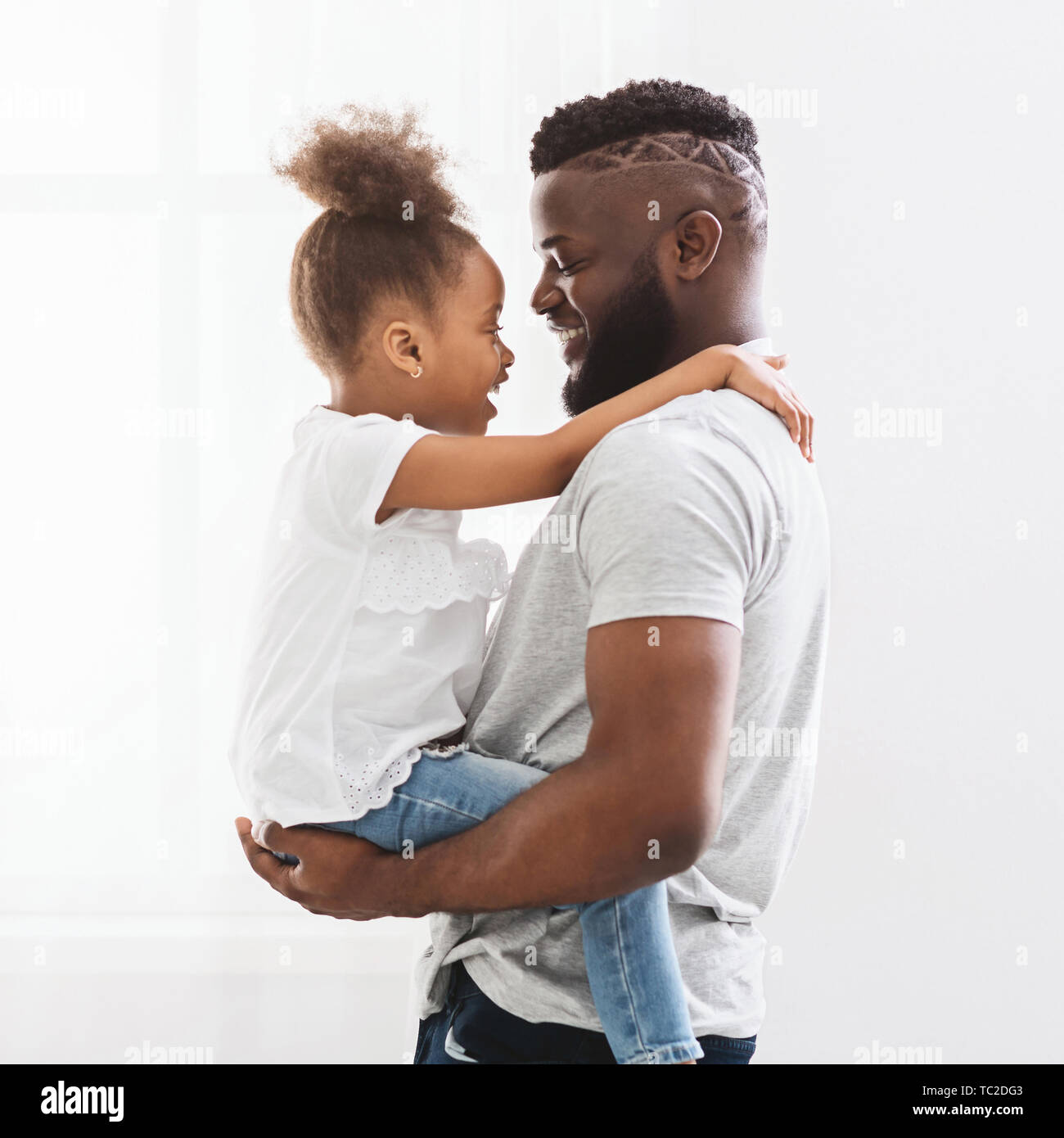 Dad hugging his little daughter at home Stock Photo - Alamy
