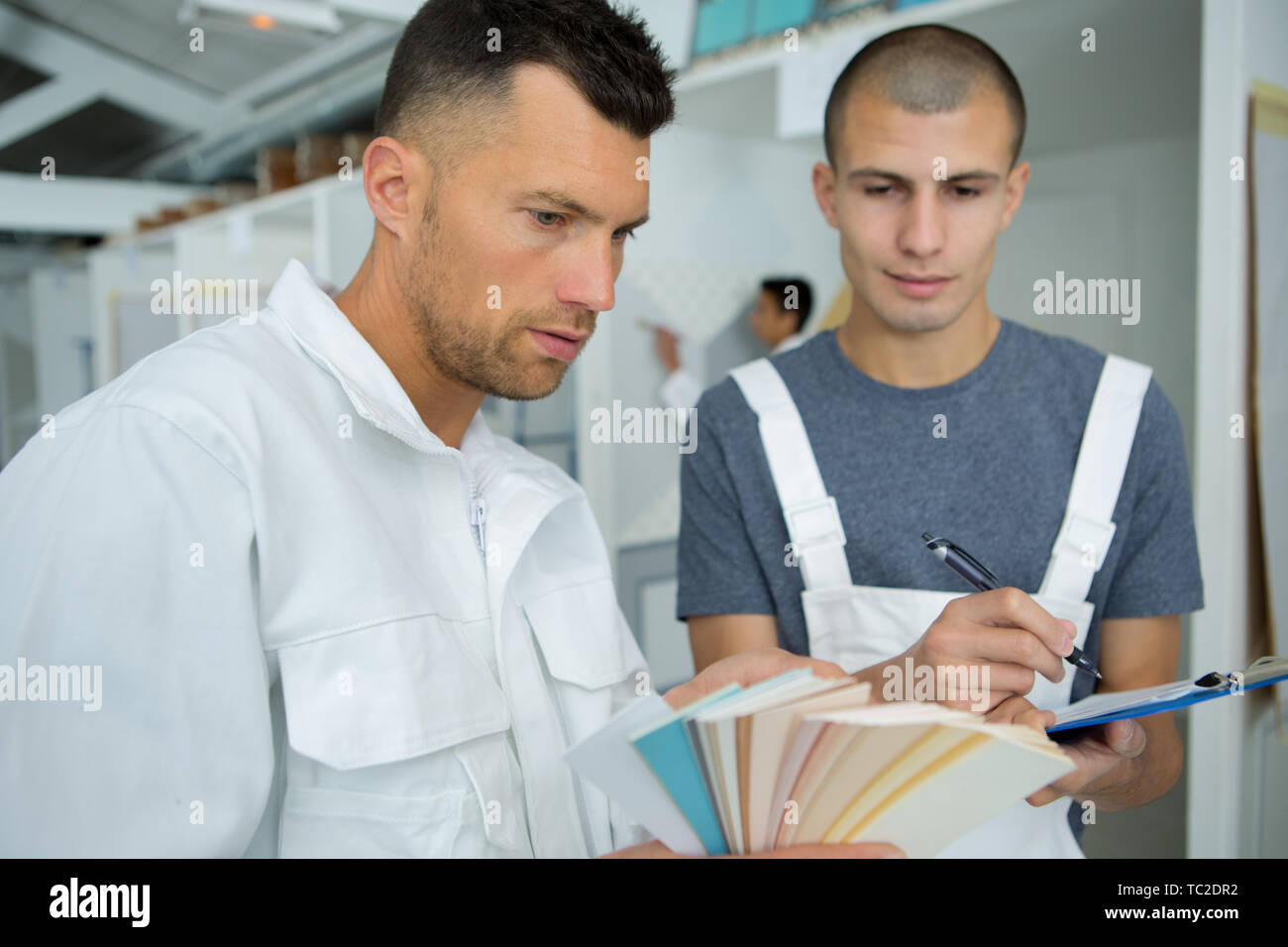 commercial painting apprentice taking notes on color names Stock Photo ...