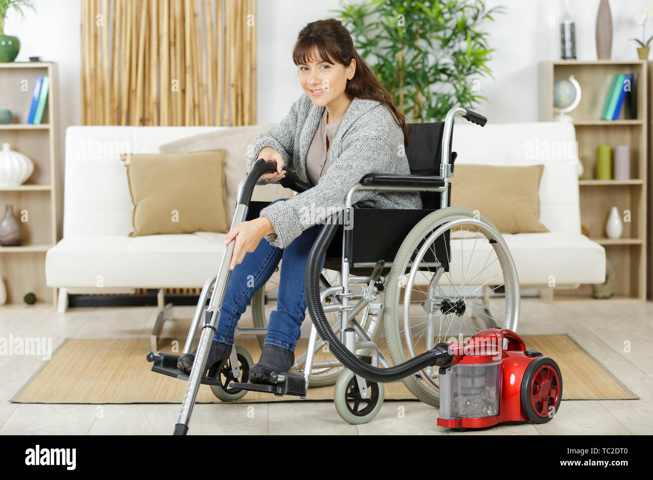 disable woman legs and vacuum cleaner Stock Photo - Alamy