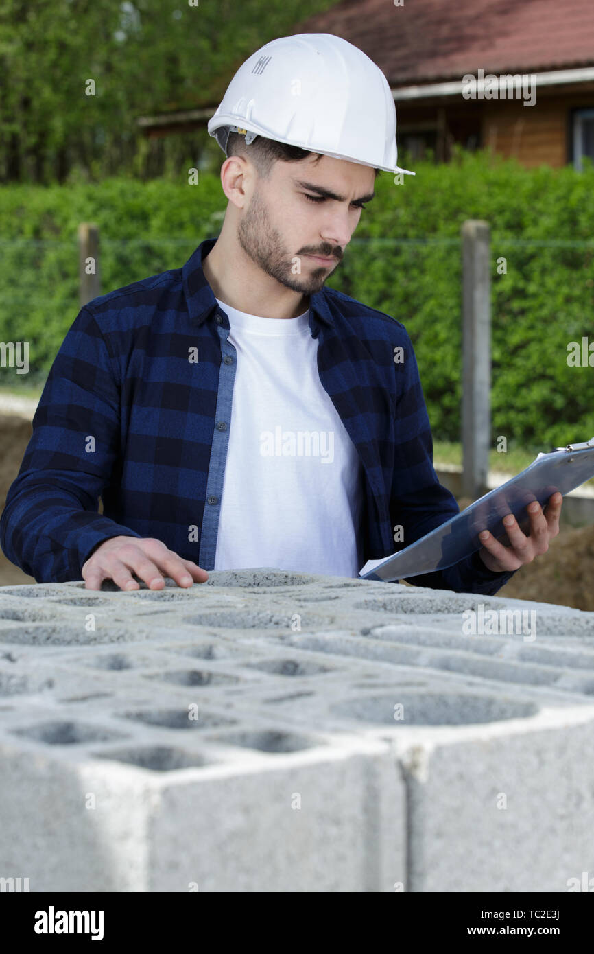 mason checks autoclaved aerated concrete blocks at a factory Stock ...