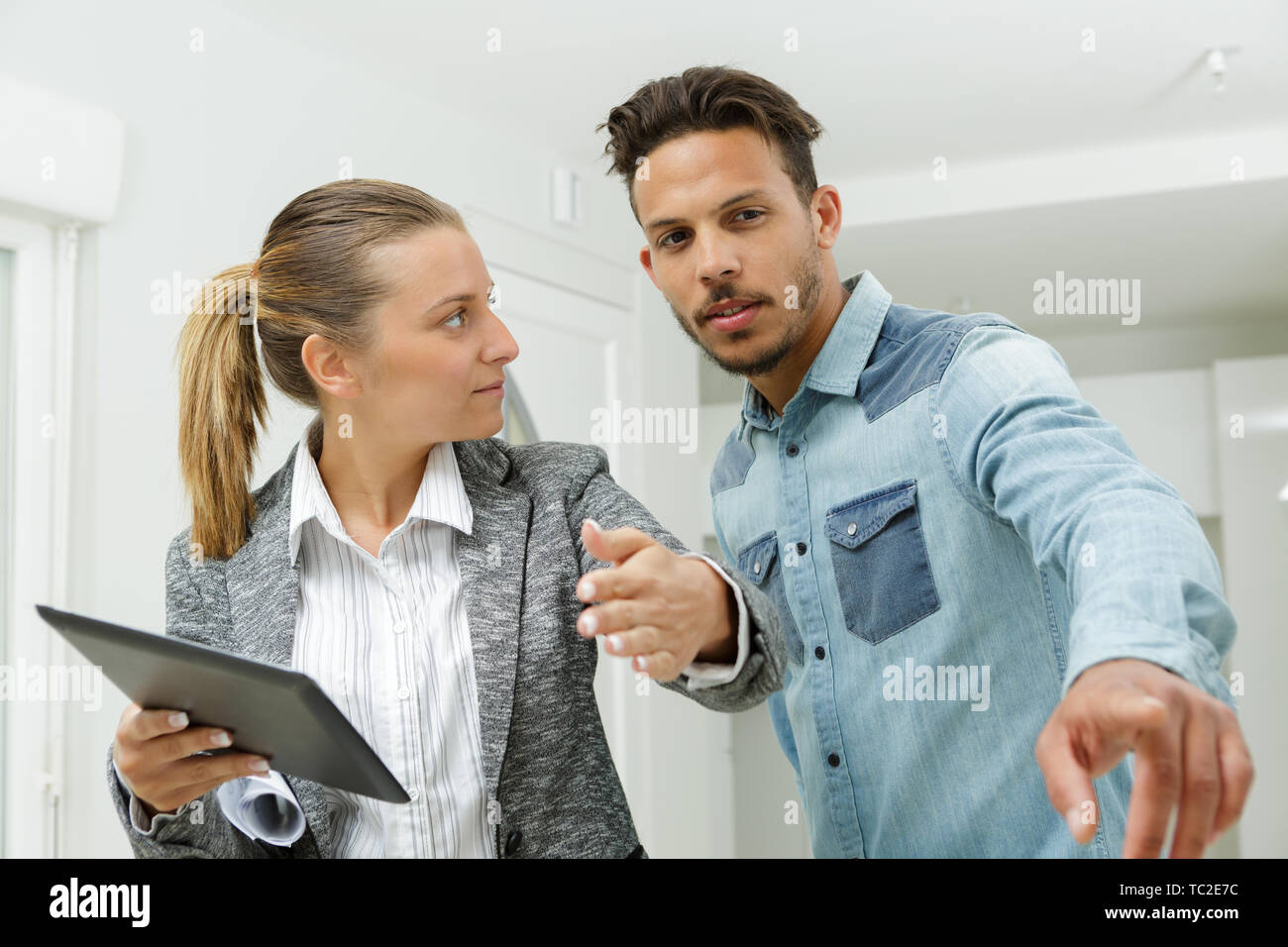 man asking questions to the estate agent while visiting apartment Stock ...