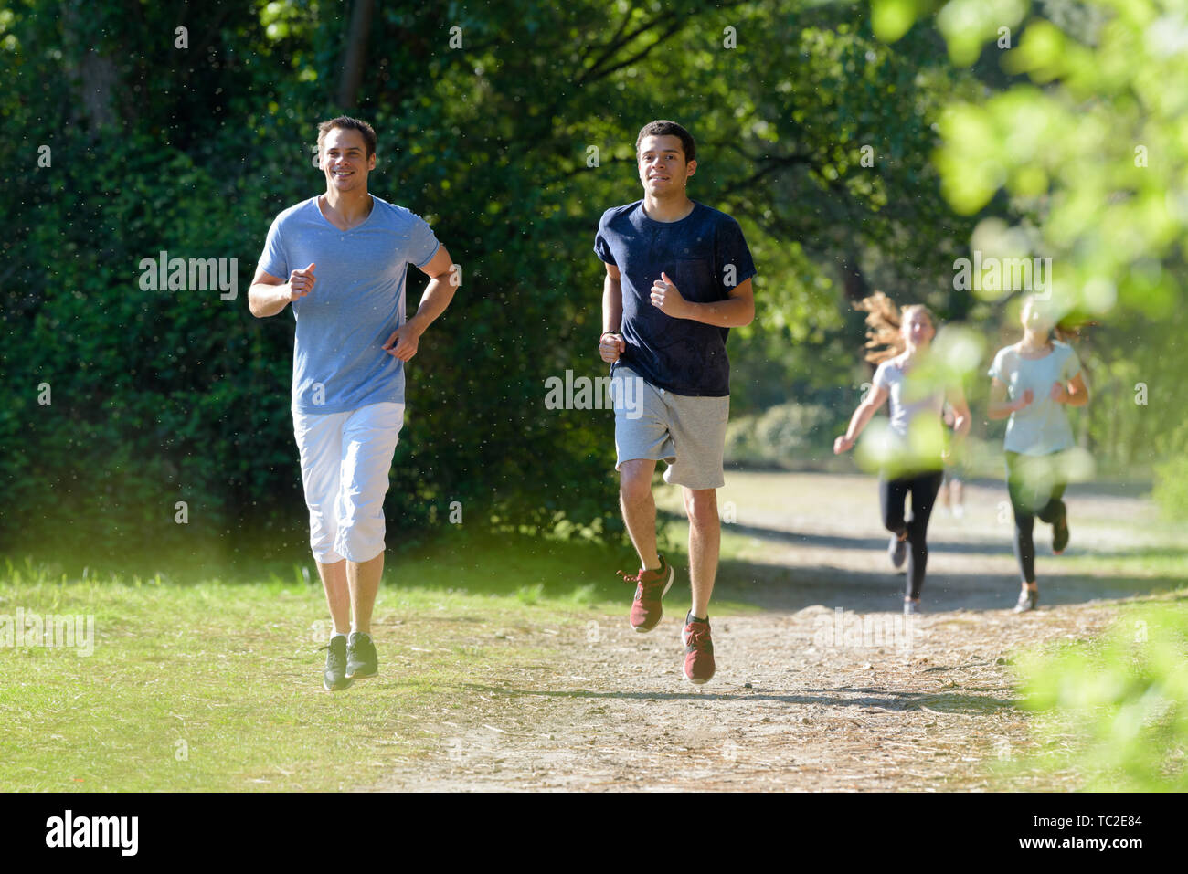 athletes running through the forest Stock Photo - Alamy