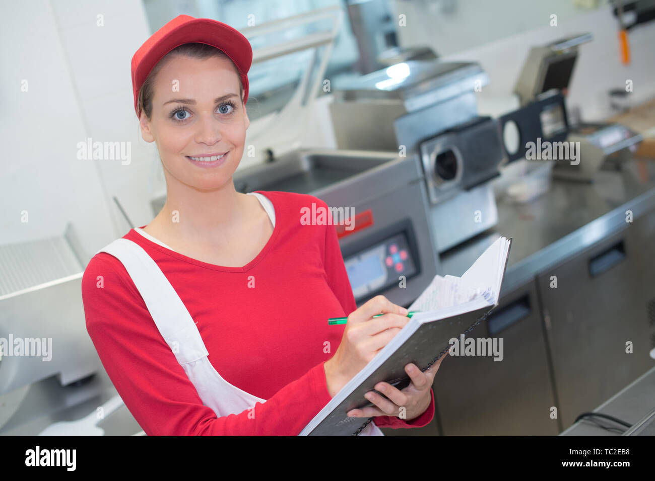 female butcher writing notes Stock Photo - Alamy