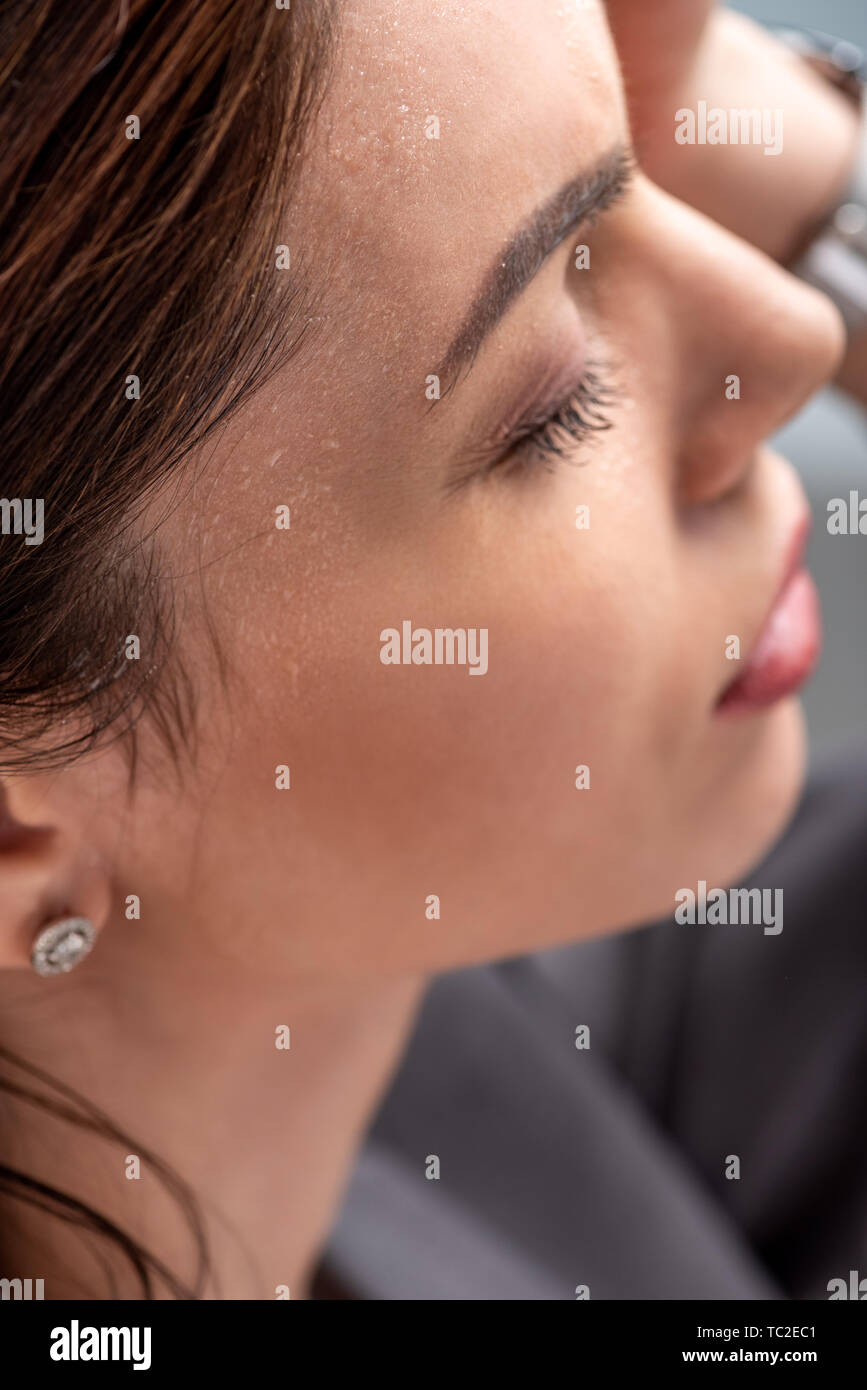 portrait of beautiful woman with sweat on face suffering from heat on ...