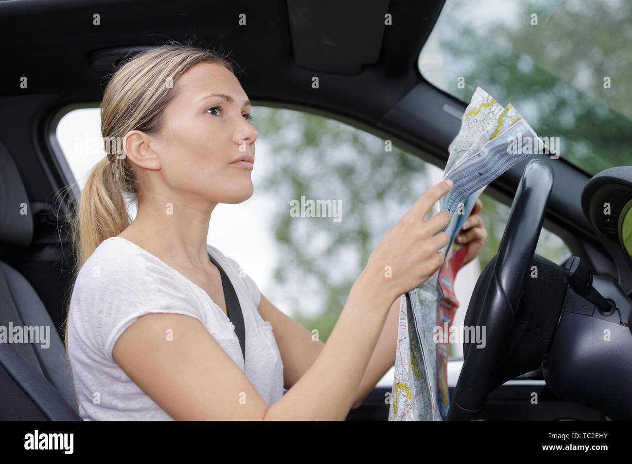 woman reading a map in a car Stock Photo - Alamy