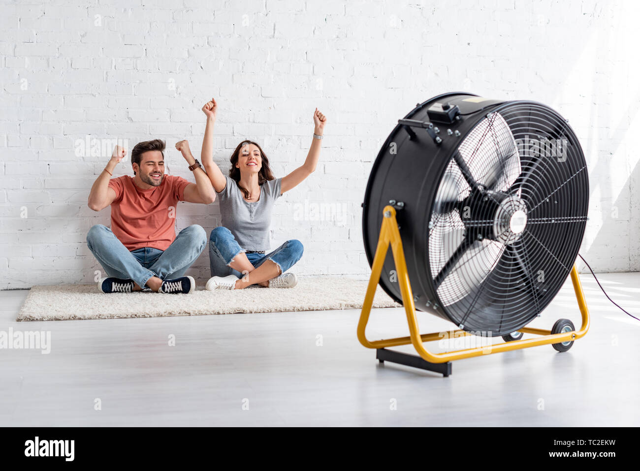 Woman sitting in front of an electric fan hi-res stock photography and ...