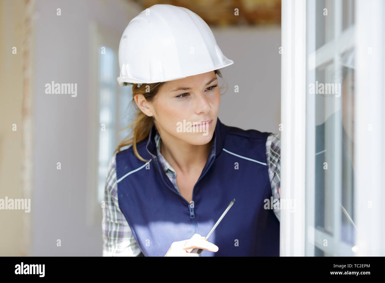 woman fixing a white window panel Stock Photo - Alamy