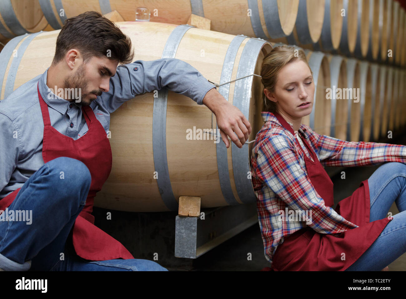 drunk wine workers sleeping next to barrels Stock Photo - Alamy