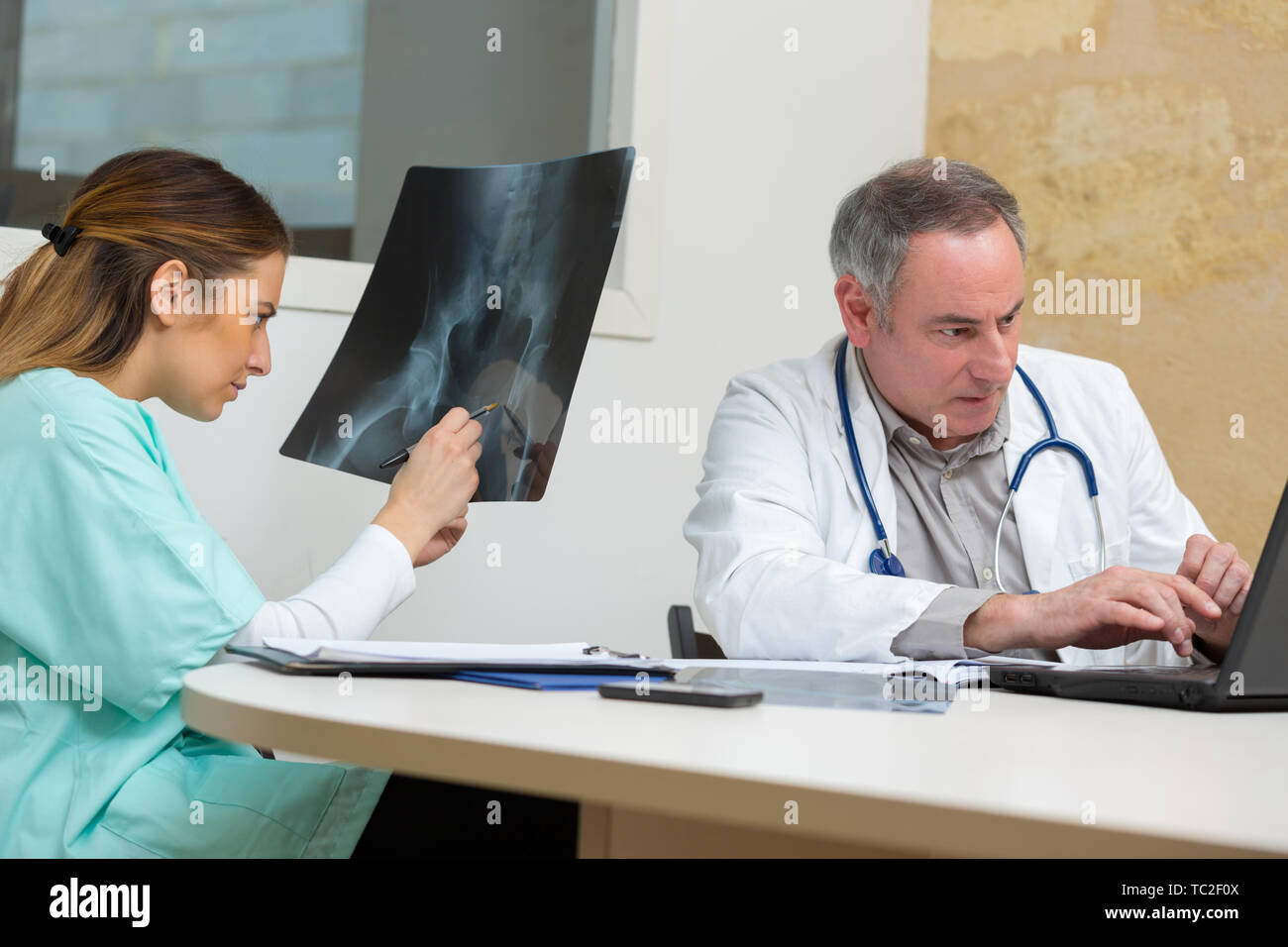 doctor showing x-ray to colleague in medical office Stock Photo - Alamy