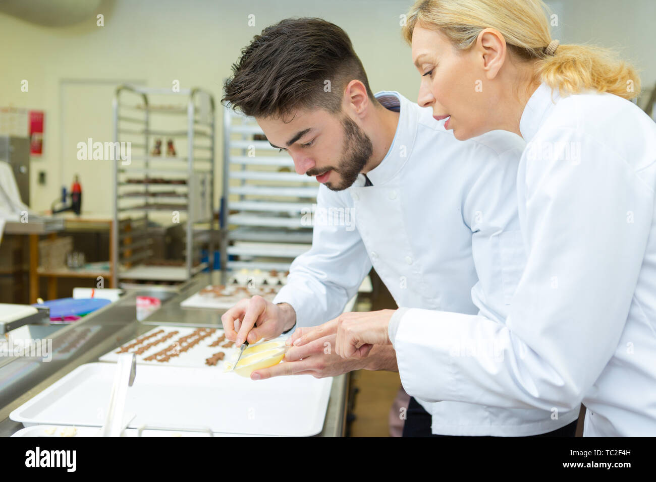female and male chefs hold bowls with butter Stock Photo - Alamy