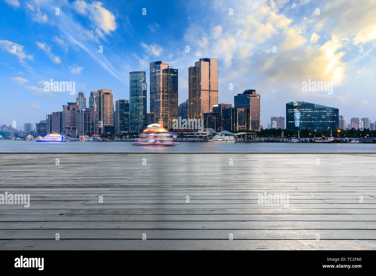 Shanghai city skyline and modern commercial office building with wooden ...