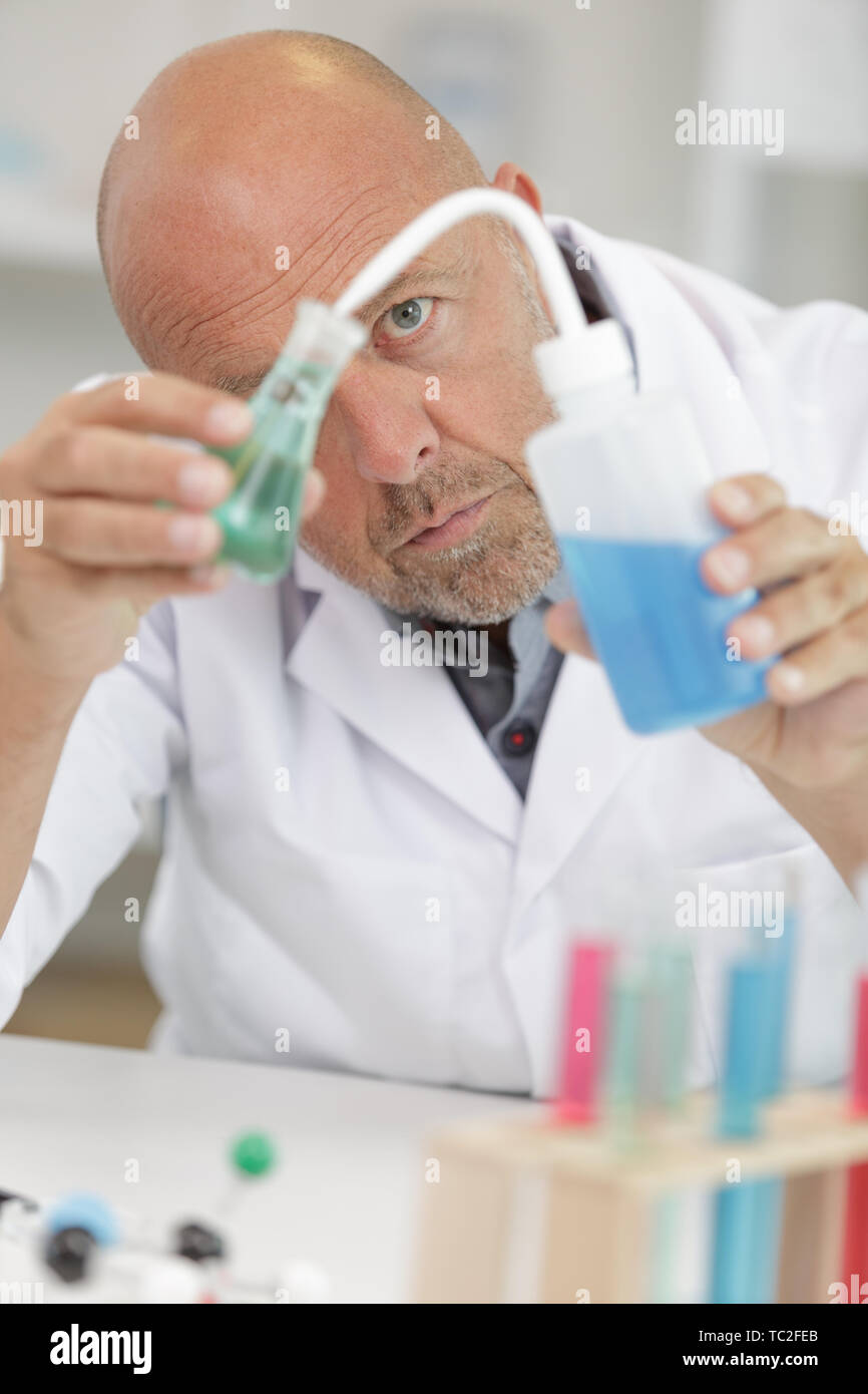 Male scientist adding solution hi-res stock photography and images - Alamy