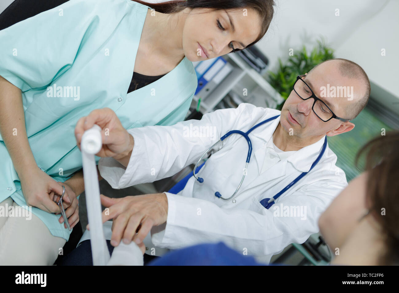 doctor bandaging an injured area Stock Photo - Alamy