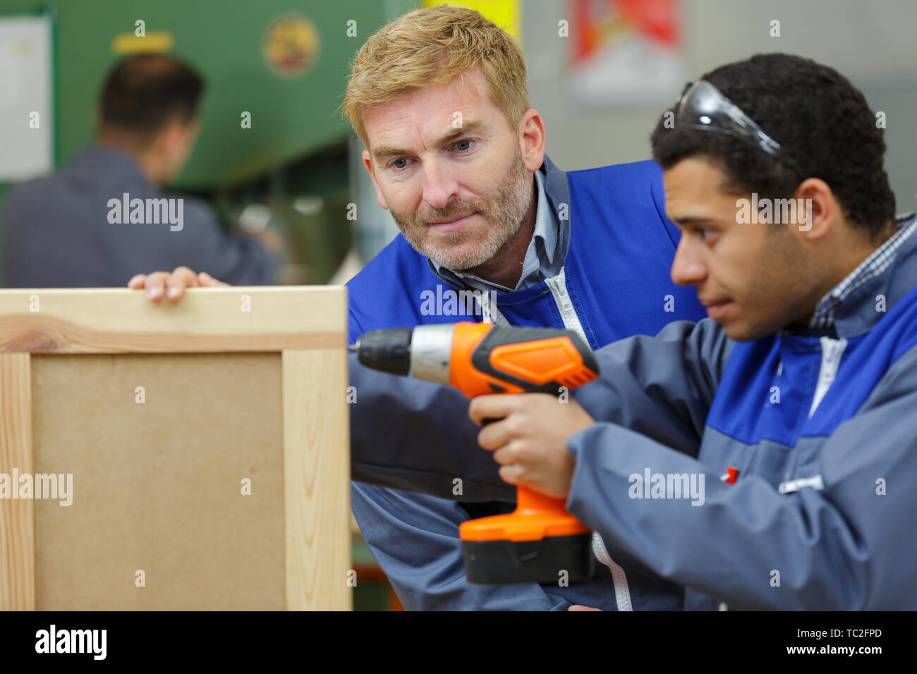 woodworking apprentice drilling the wood Stock Photo - Alamy