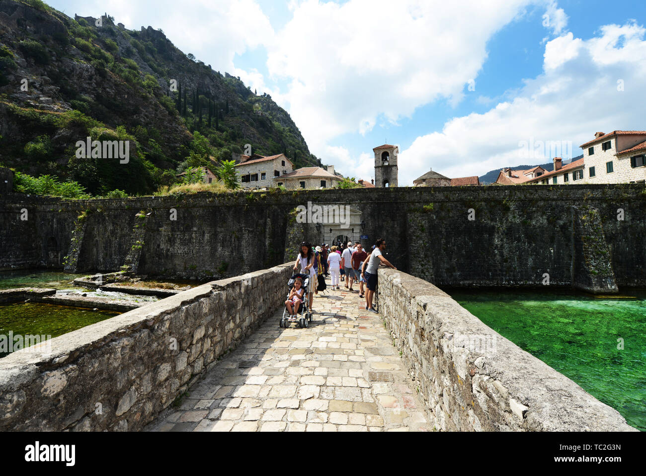 Tourist crossing the bridge near Vrata od Škurde in the old town of ...