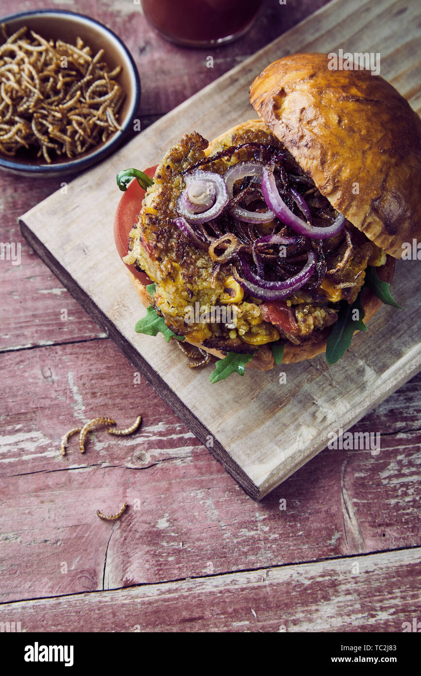 Speciality bug or insect burger with fried crunchy mealworms on a ...