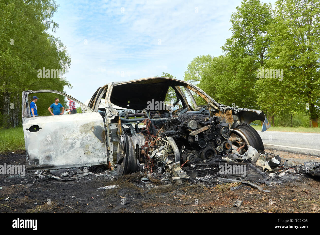 Fully burned car after collision with truck in summer, accident ...