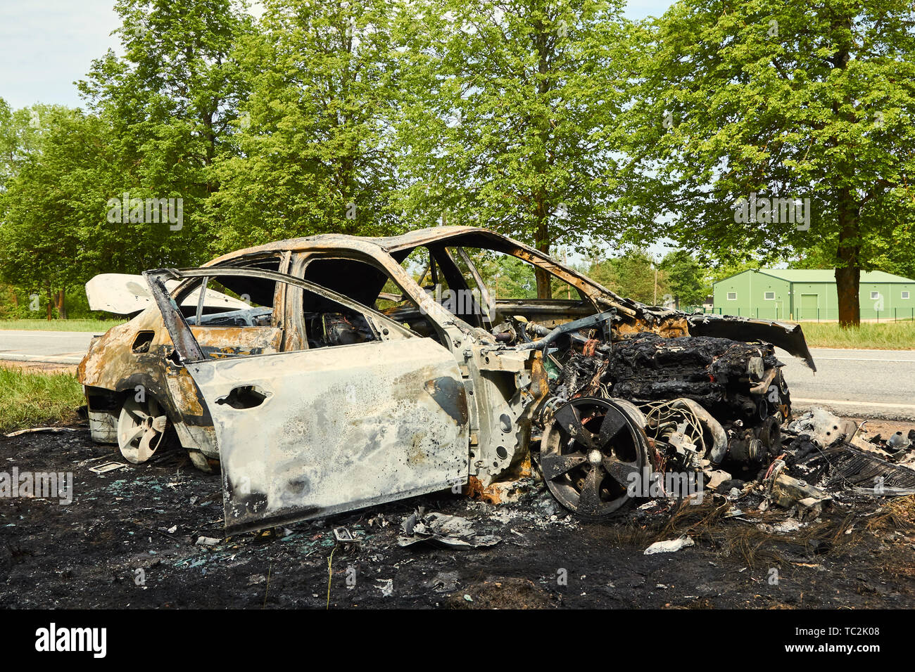 Fully burned car after collision with truck in summer, accident ...