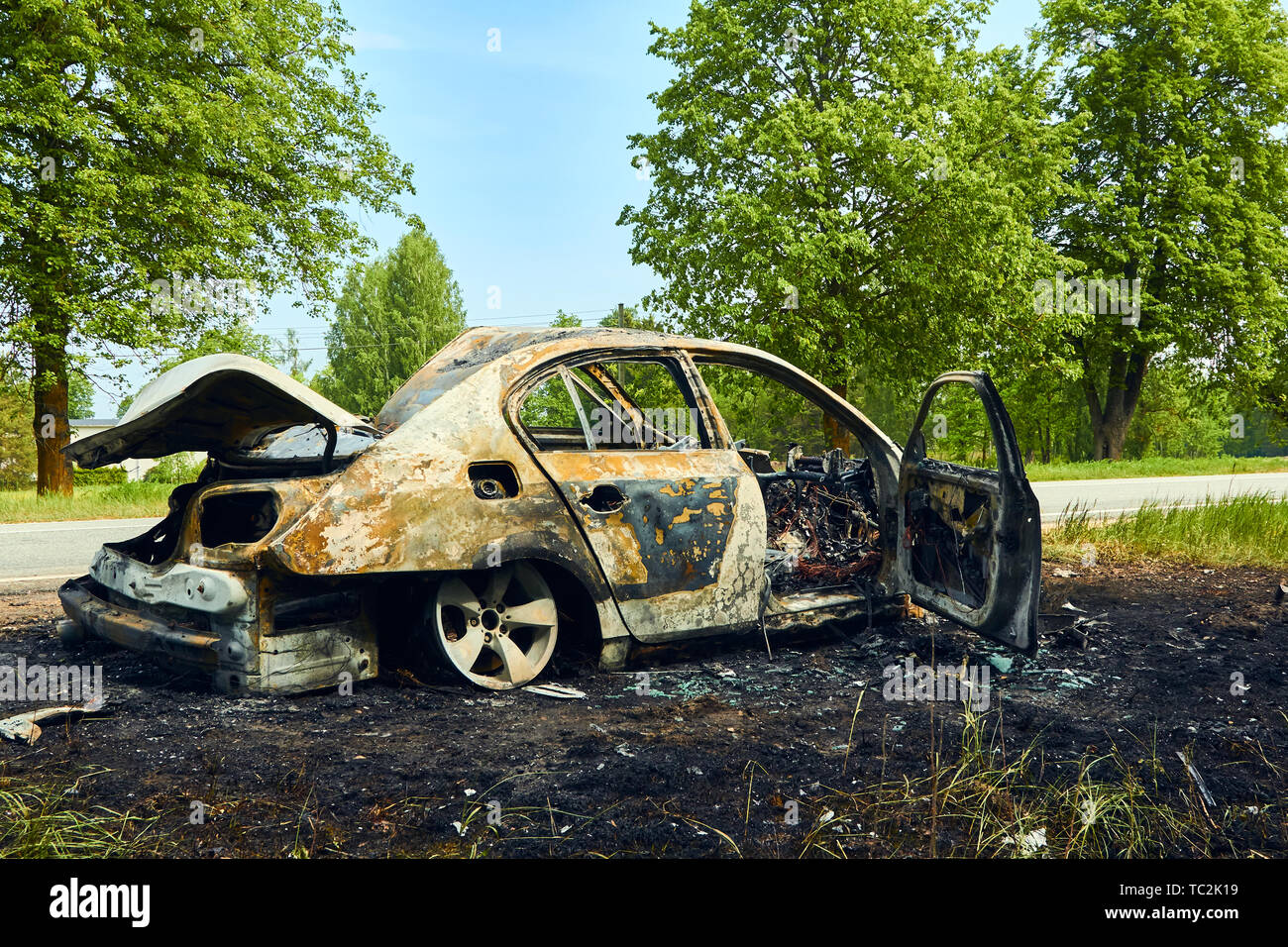Fully burned car after collision with truck in summer, accident ...