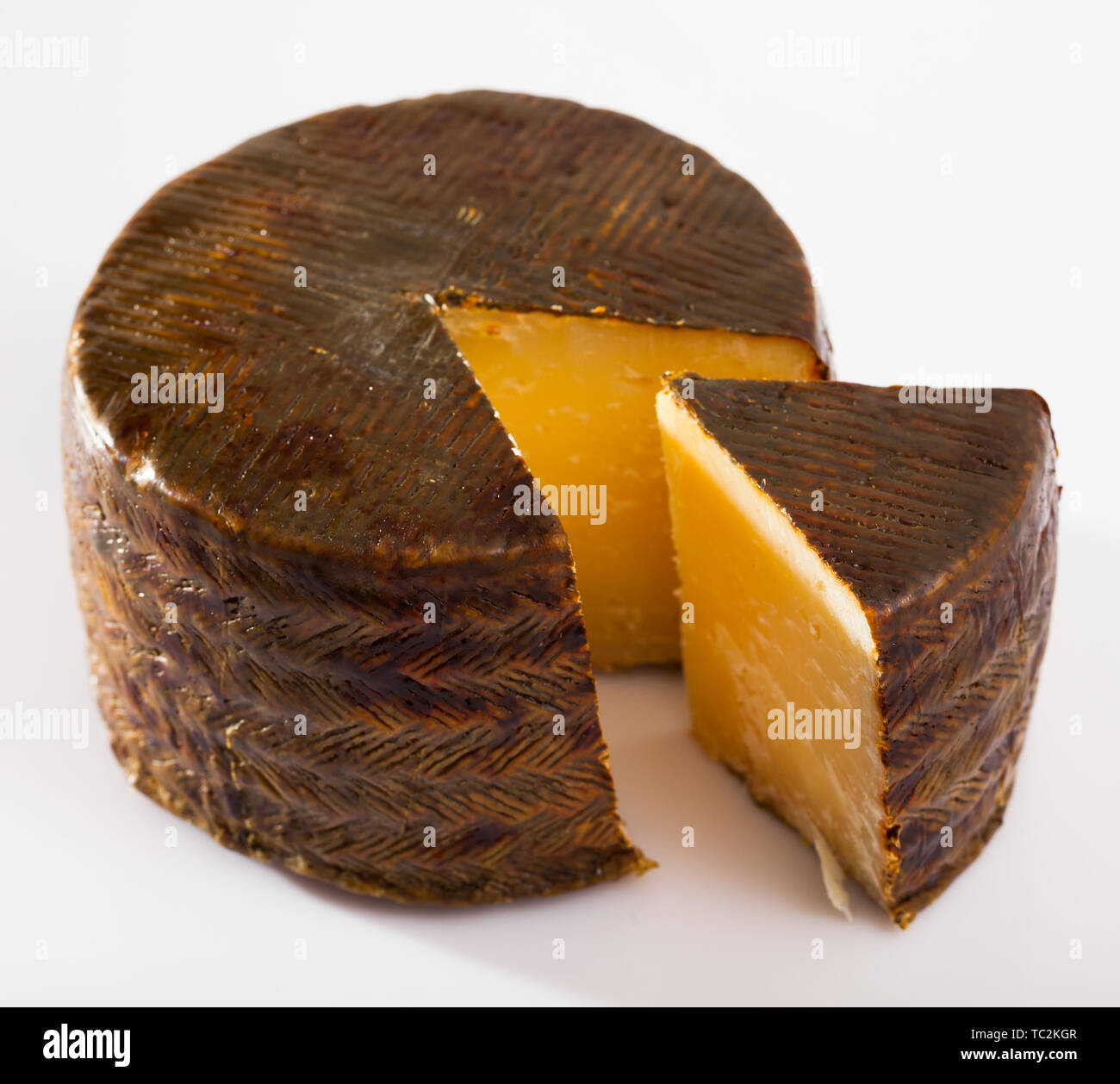 Spanish manchego cheese on a white surface Stock Photo - Alamy