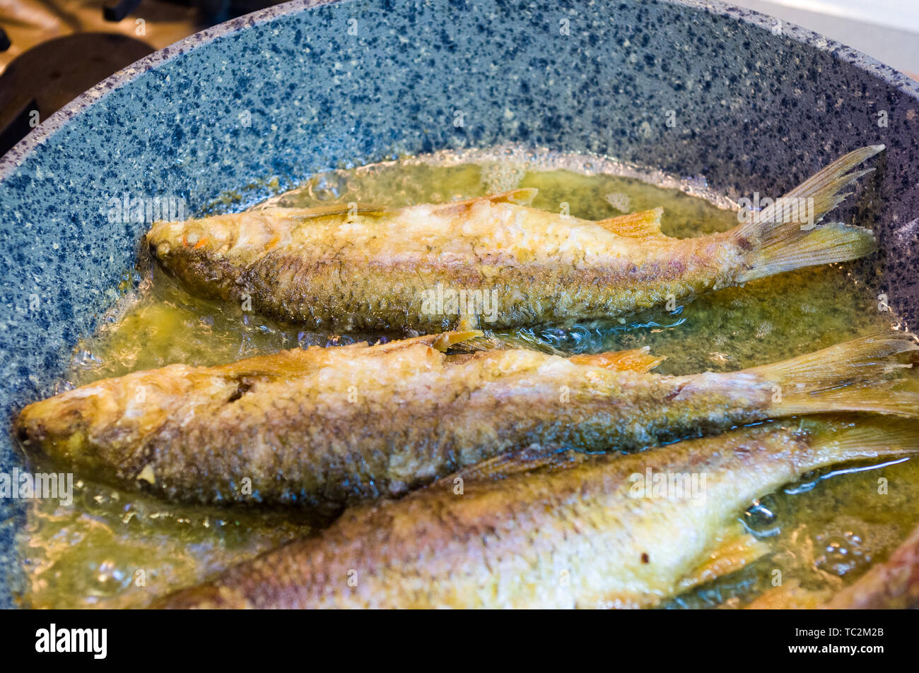 fried river fish with crispy crust in a frying pan, homemade dish Stock ...
