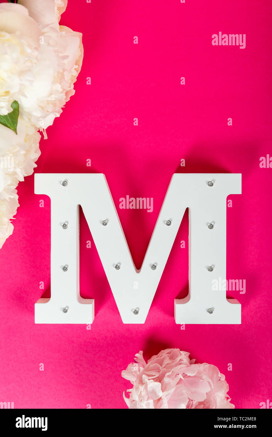 Wooden decorative letter M on pink background Stock Photo - Alamy