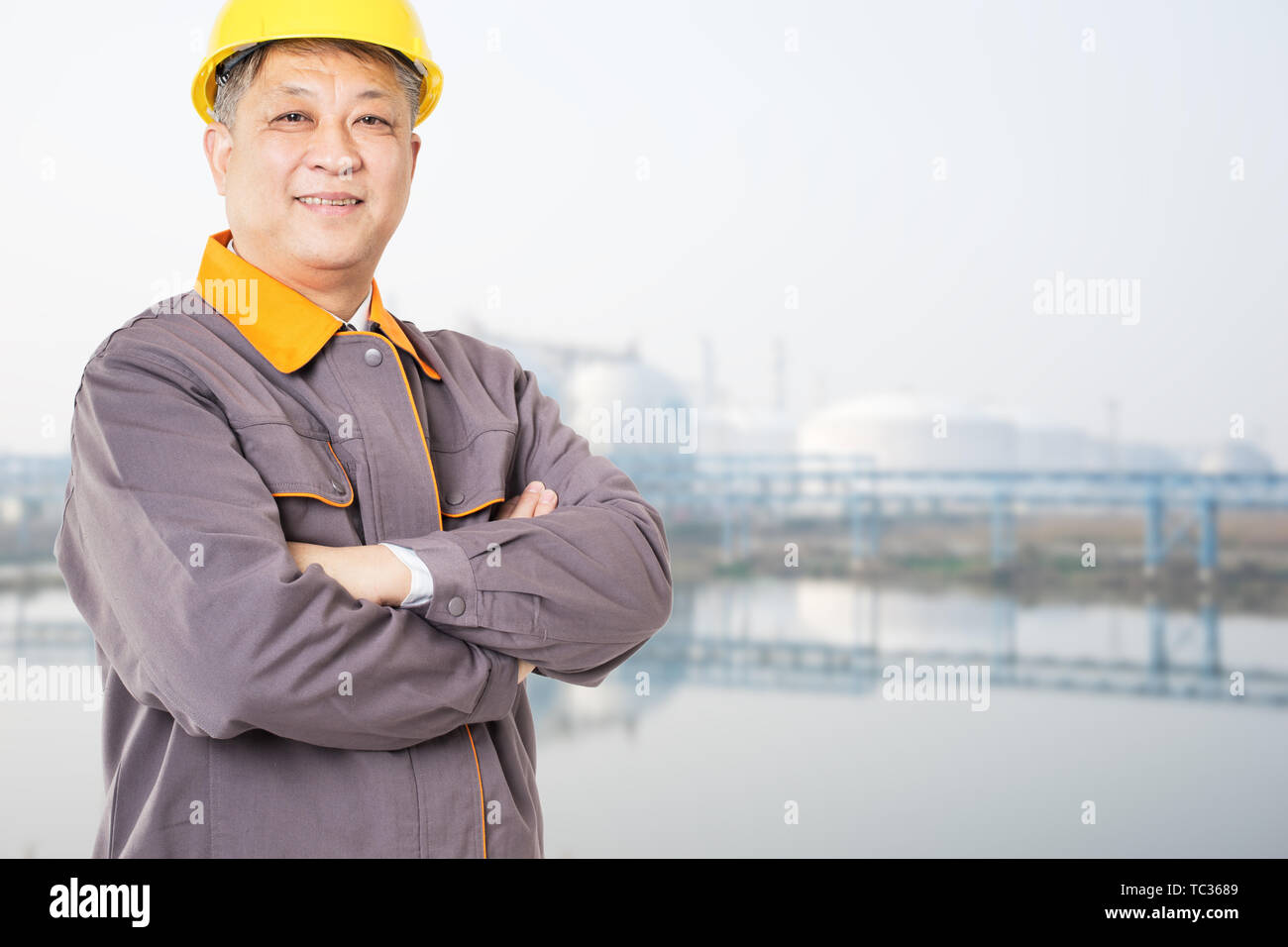 old chinese man engineer in oil refinery plant Stock Photo - Alamy