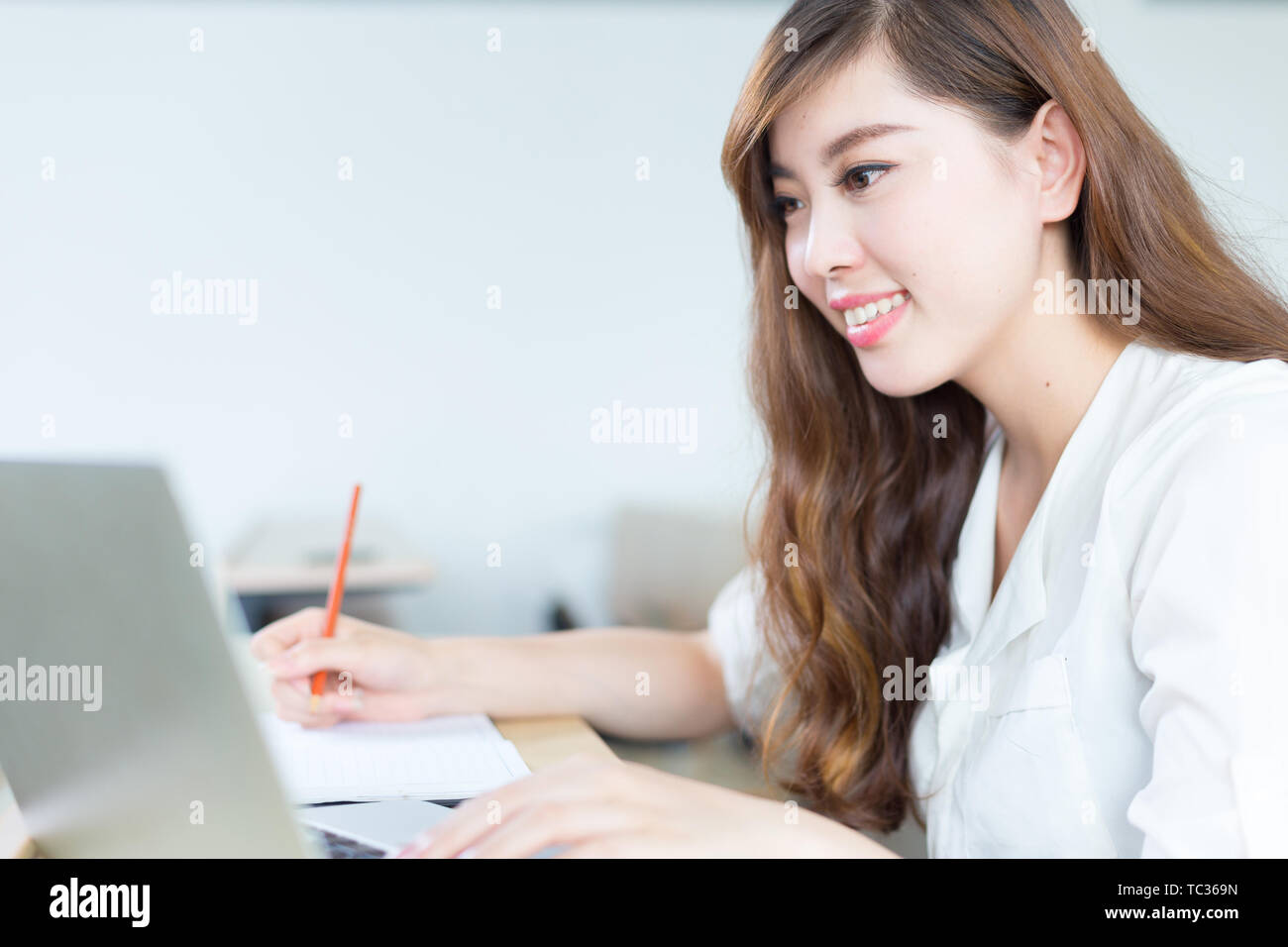 young beautiful asian girl student with laptop in classroom Stock Photo ...