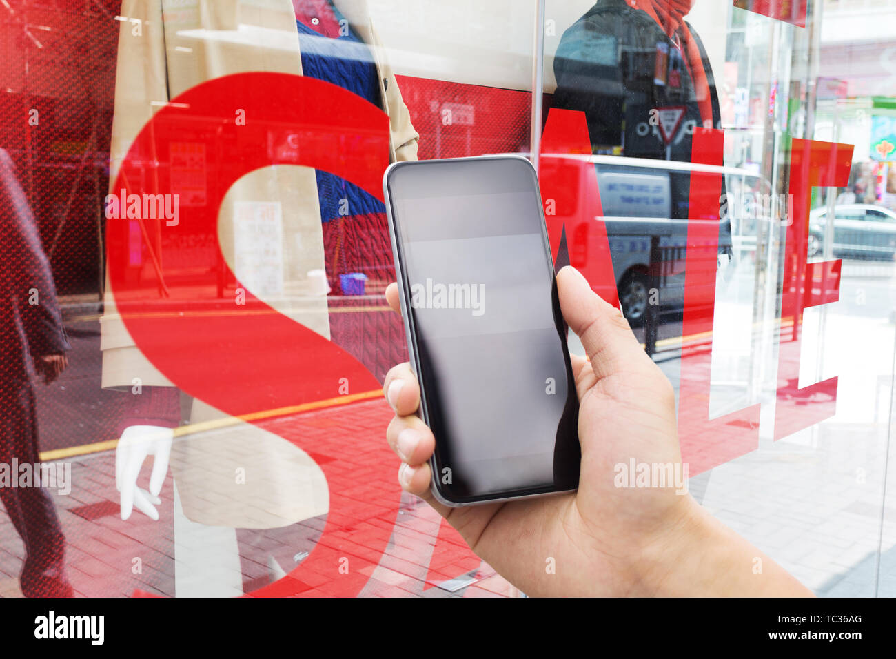 Mobile phone with red sale sign Stock Photo - Alamy
