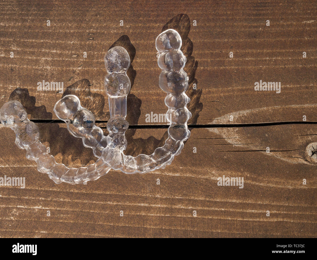 Transparent dental retainer or clear retainer on the table wooden ...