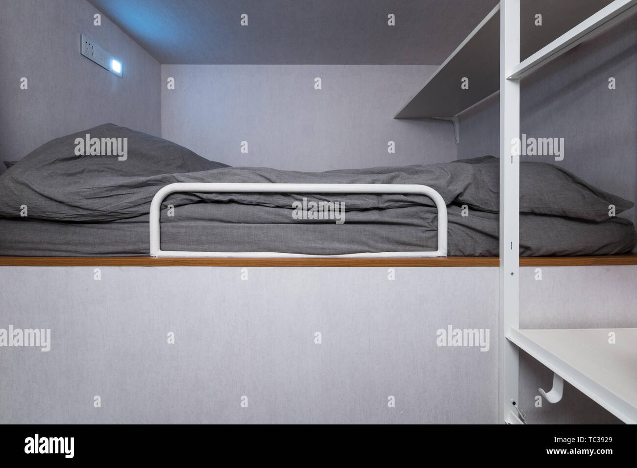 Simple bed with soft quilt Stock Photo - Alamy