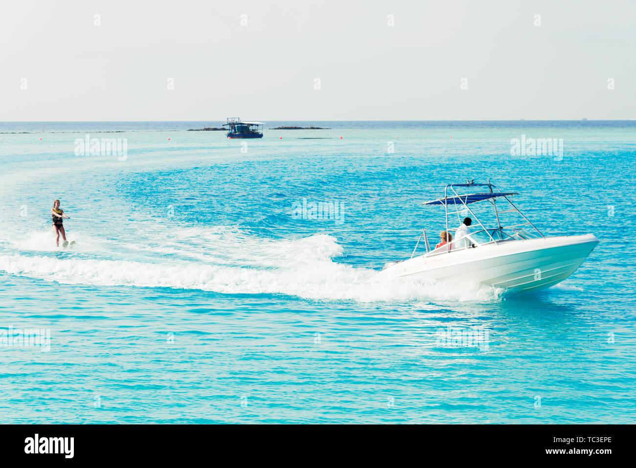 beautiful tropical sea with motorboat and water skier Stock Photo - Alamy