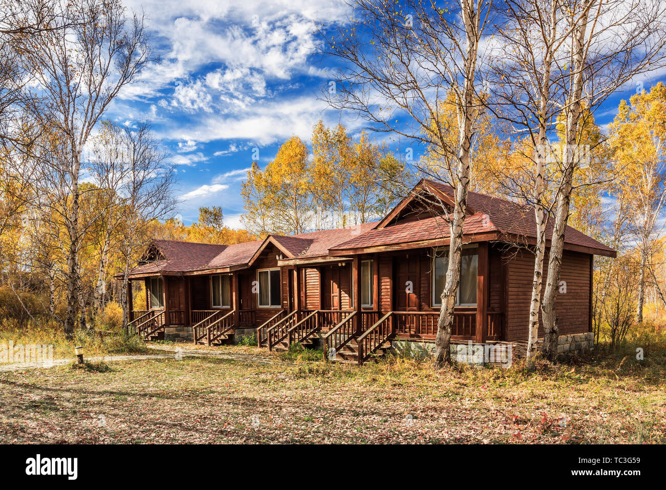 Paddock dam on sun lake lake wooden house autumn color Stock Photo - Alamy