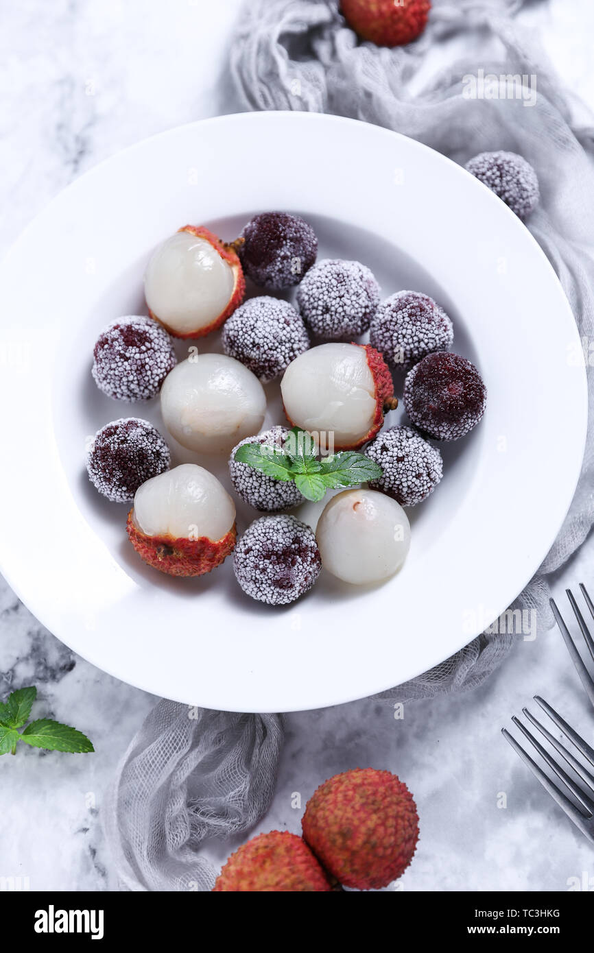 Frozen plum and fresh lychee Stock Photo - Alamy