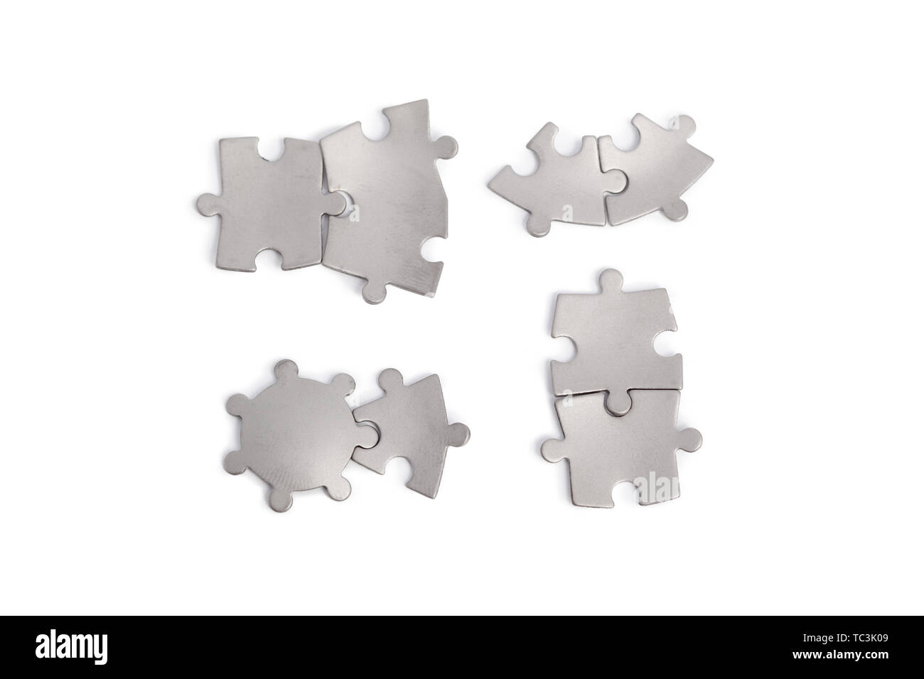 Metal puzzle pieces isolated on white Stock Photo - Alamy
