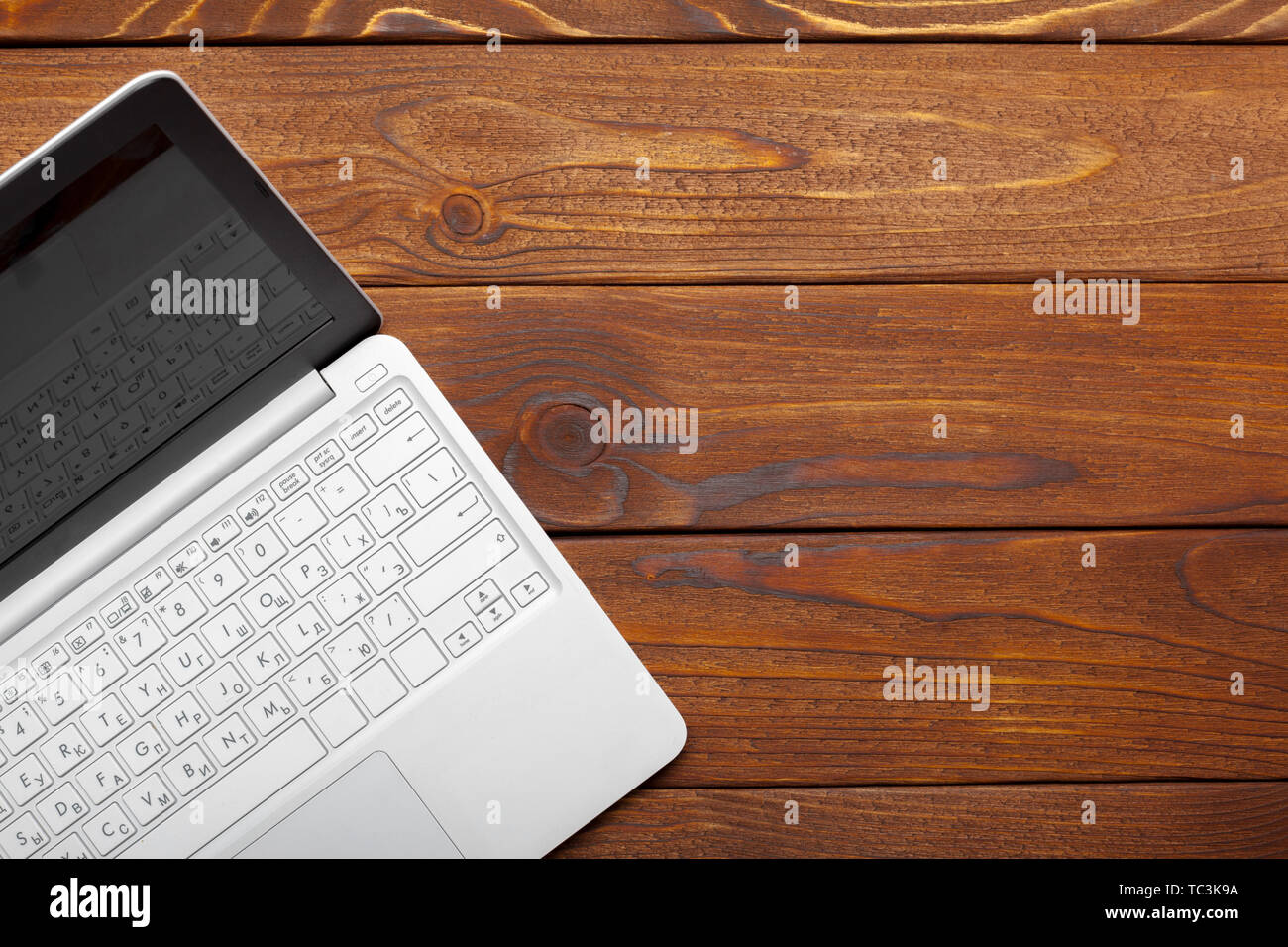 Laptop, notebook on work wooden desk Stock Photo - Alamy