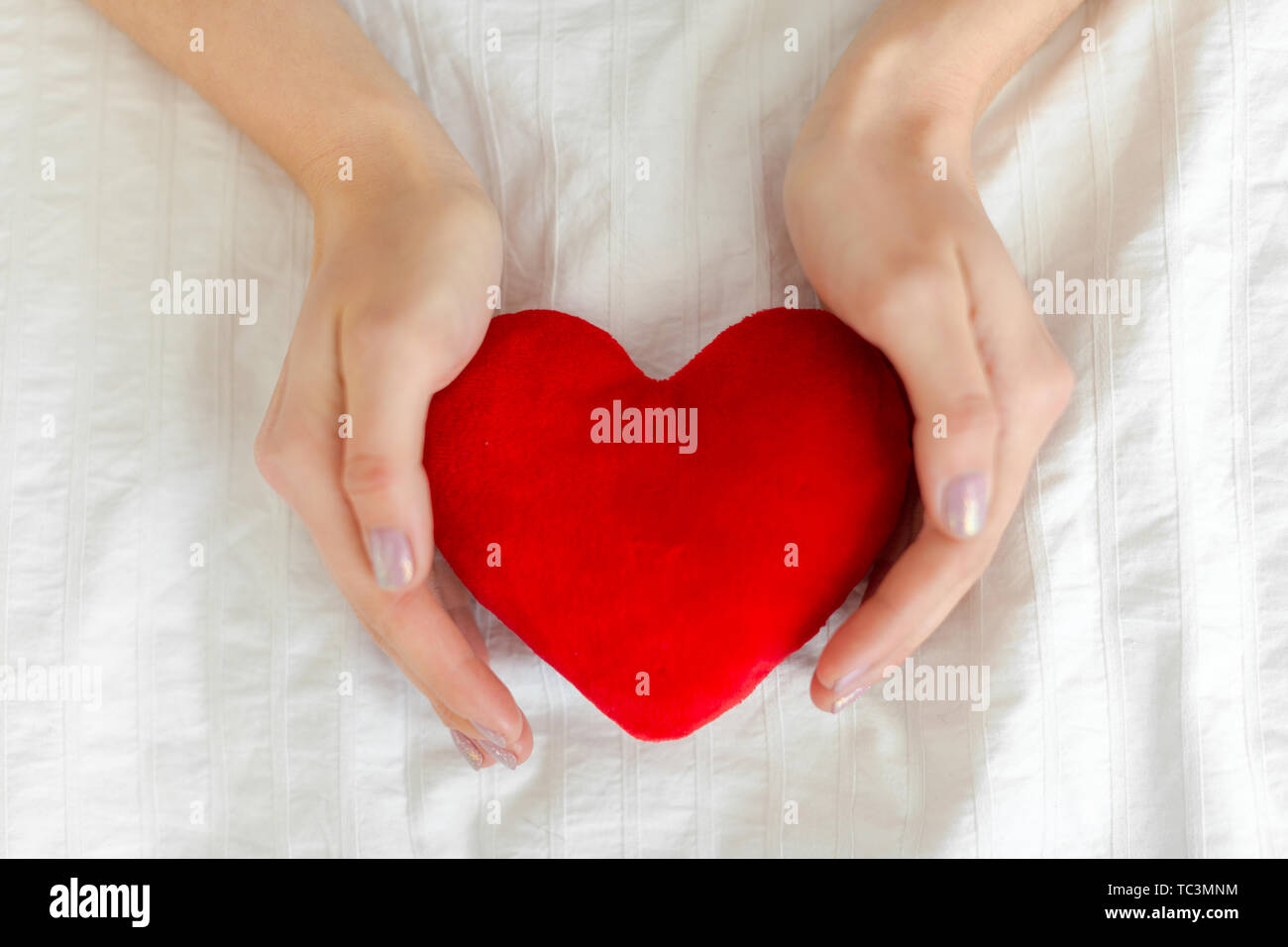 Heart in hands Stock Photo - Alamy