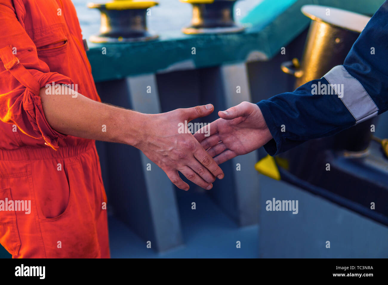 marine contractor businessman handshaking with worker on the ship Stock ...