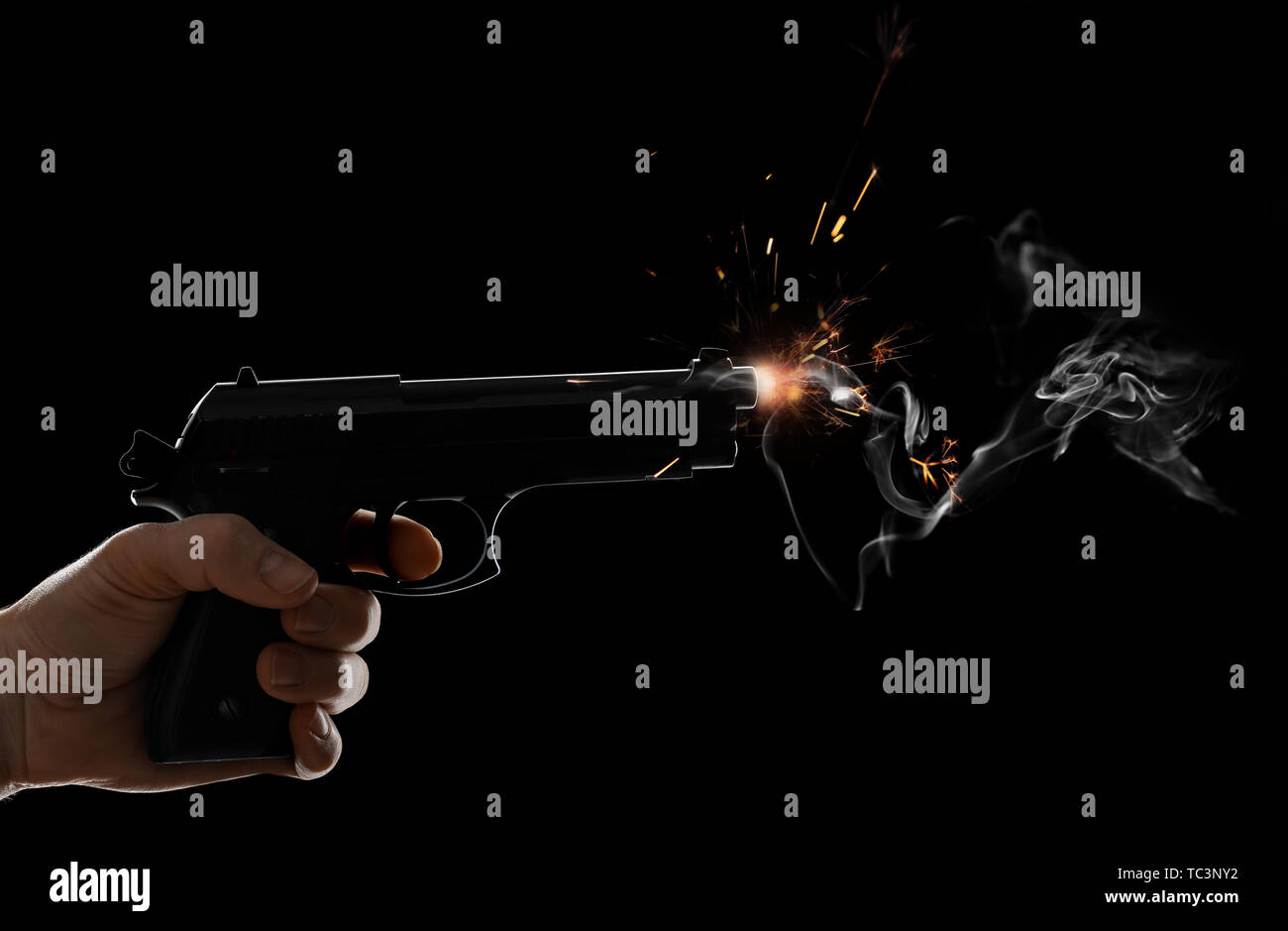 Male hand with firing gun on dark background Stock Photo - Alamy
