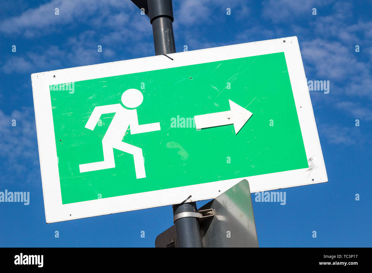 Emergency exit sign fixed on street lamp pole Stock Photo - Alamy