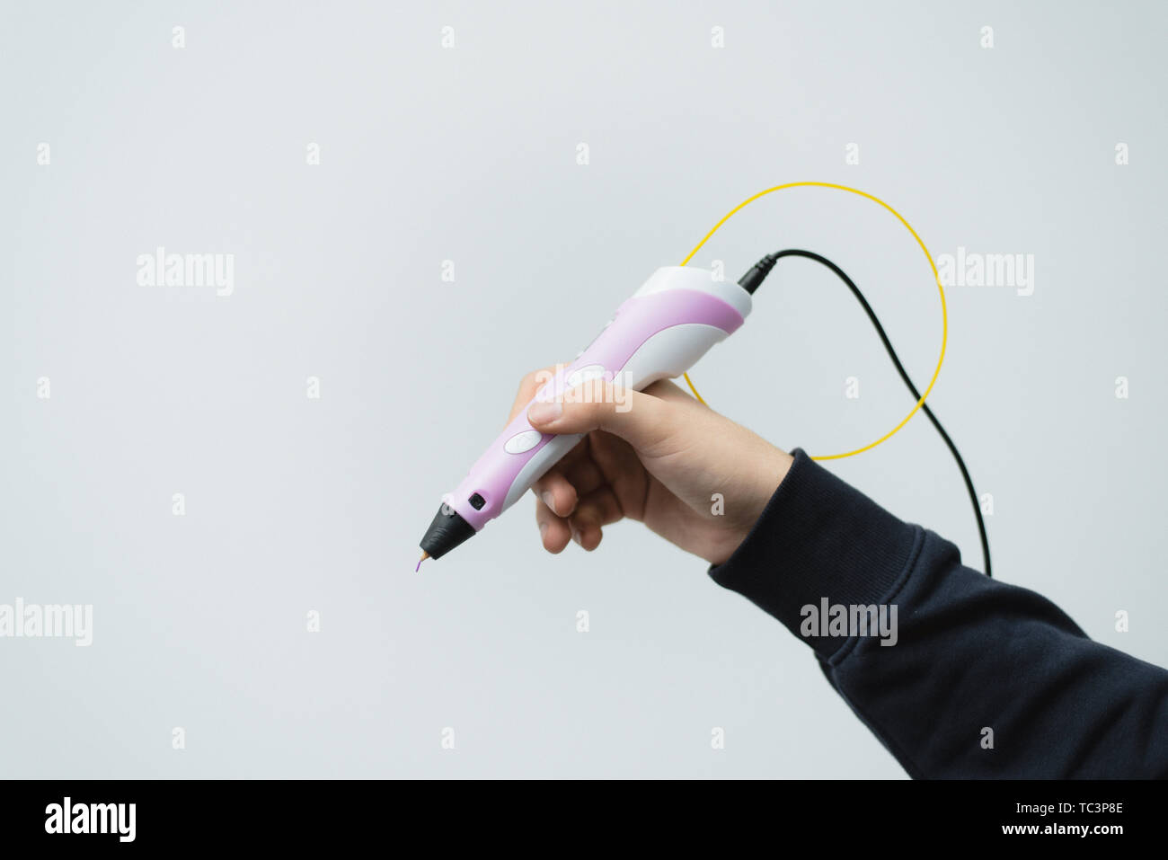 A man holds a 3d pen in his hand. 3d pen in a man's hand. Drawing ...